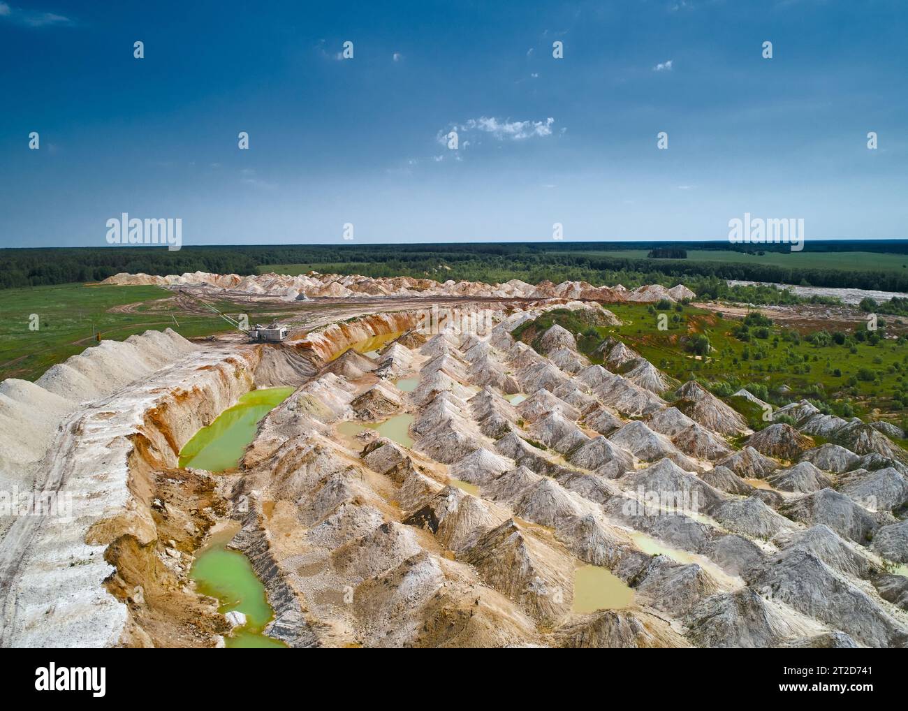 Limestone piles lines and water in trench at mining quarry Stock Photo ...