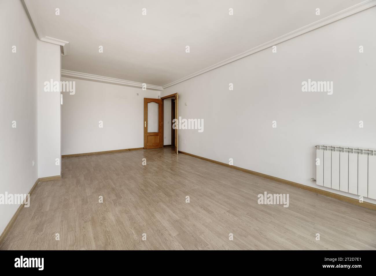 Empty living room of a detached house with doors to other rooms, wooden ...