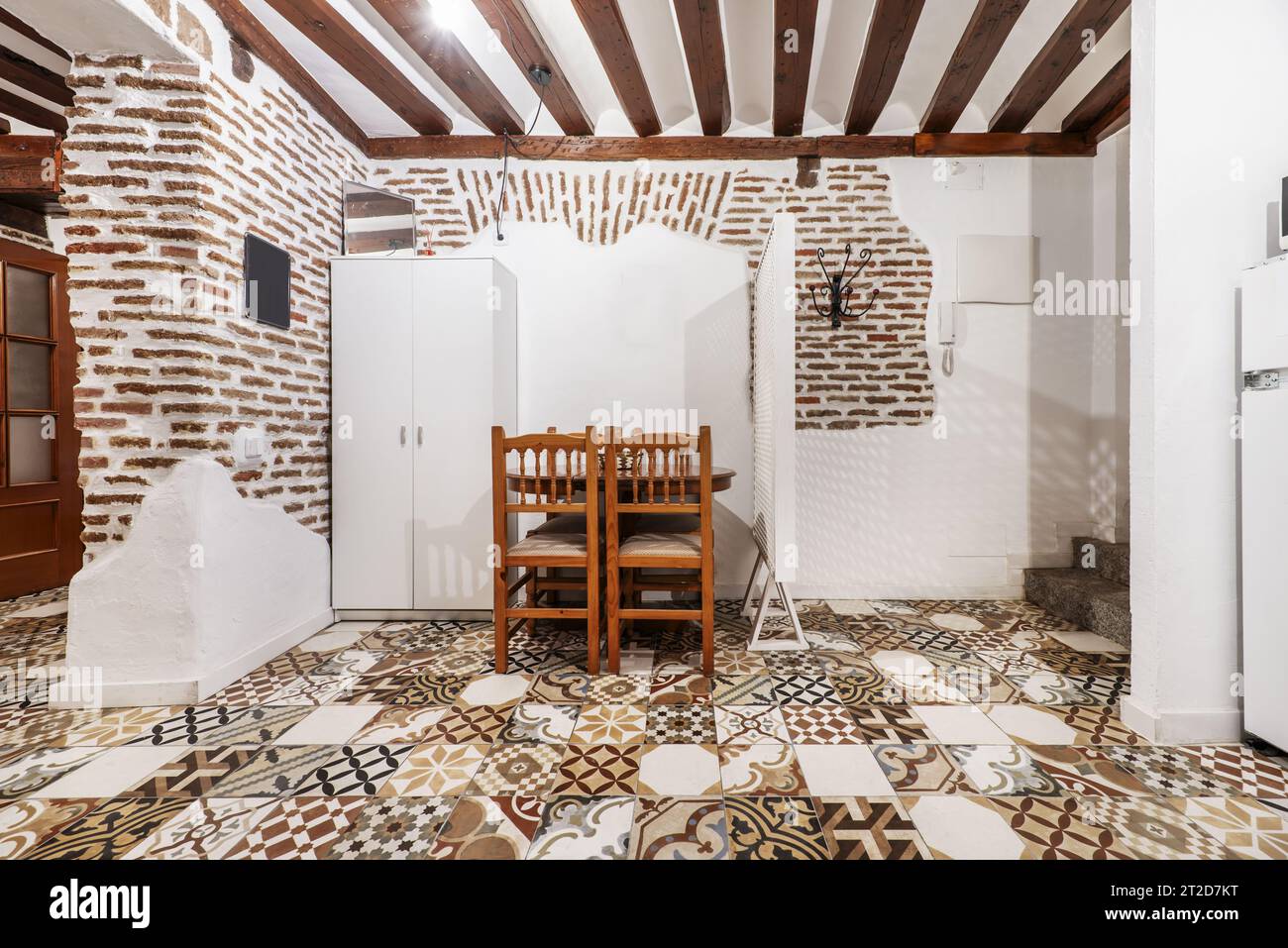 Room in an ornate old country-style apartment with exposed brick walls ...