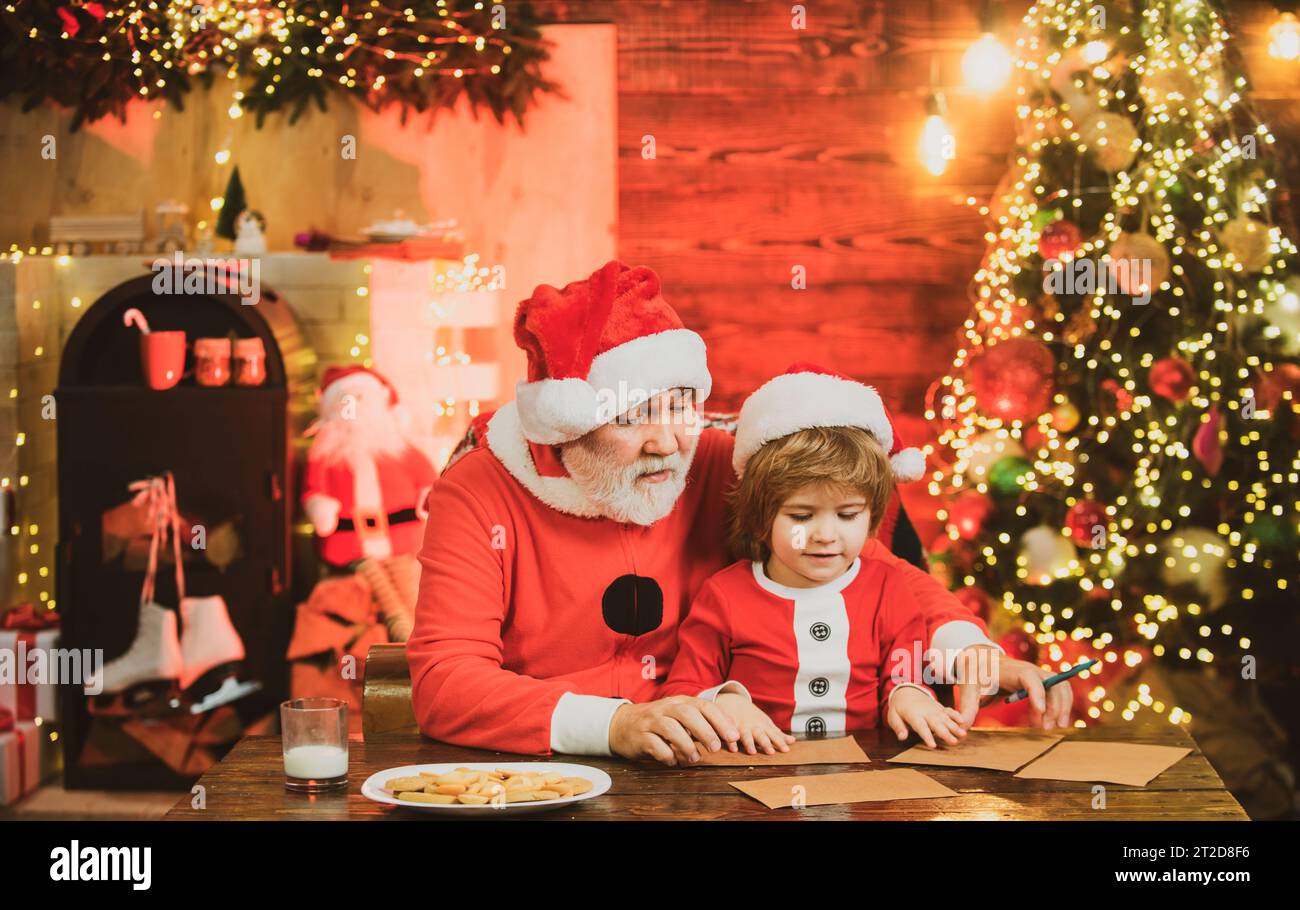 Christmas helper and Santa writing or reading letter home near the ...