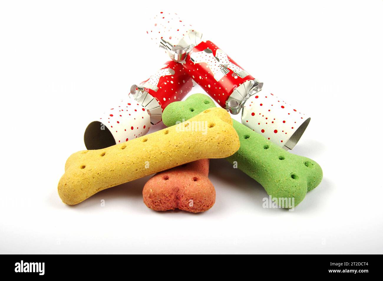 colourful dog biscuit bones and festive christmas crackers on a white ...