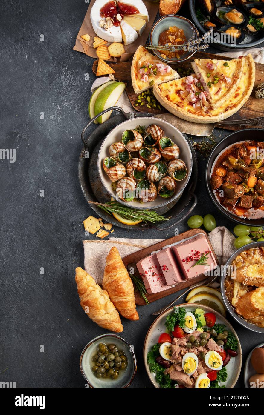 French food assortment on dark background. Traditional cuisine concept ...