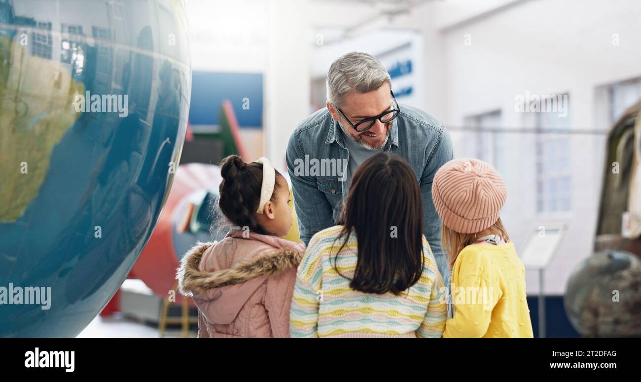 Science, geography and kids learning about the earth with a teacher at ...
