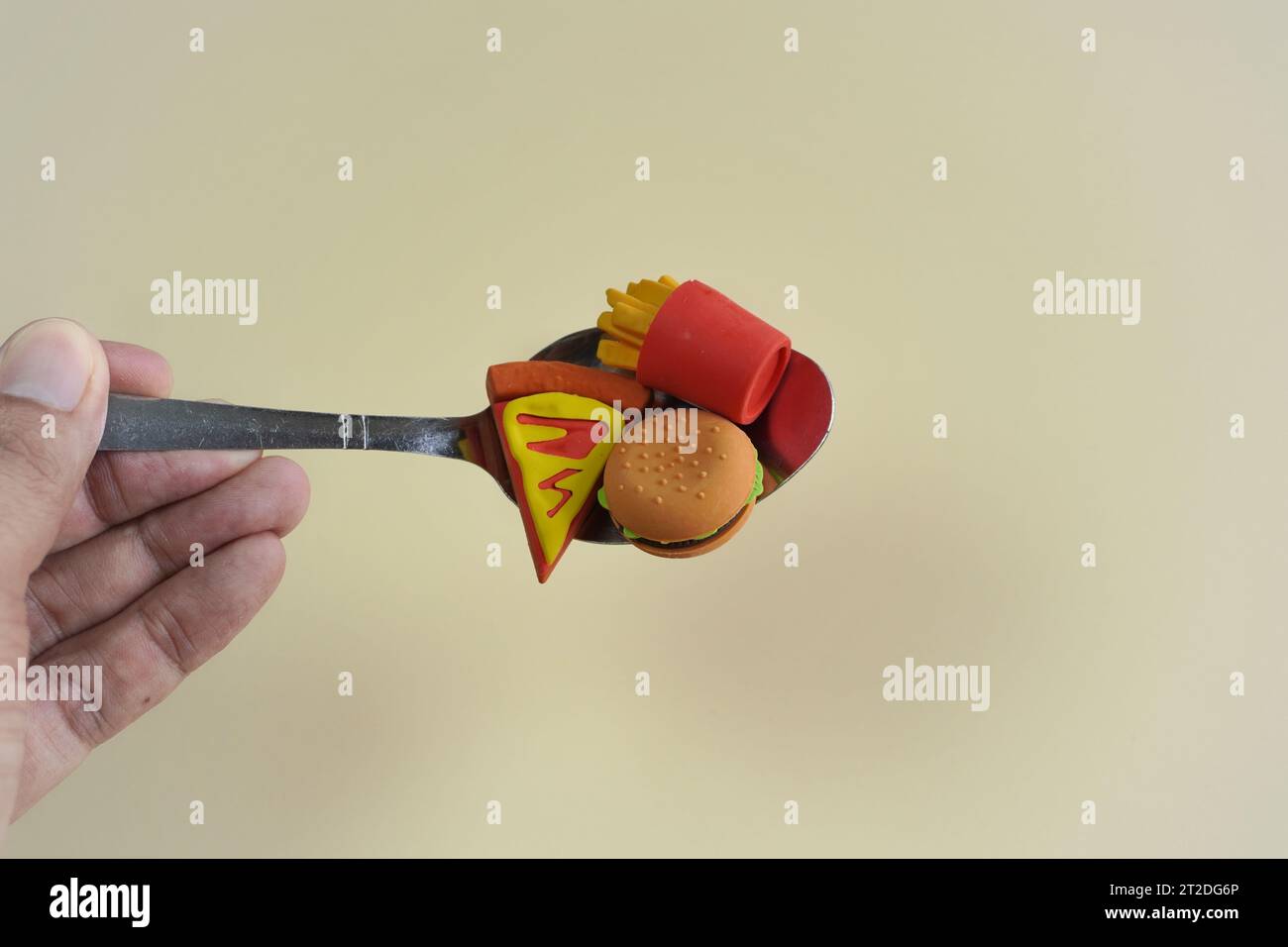 Closeup image of spoon fill with junk food. Bad eating habits concept ...