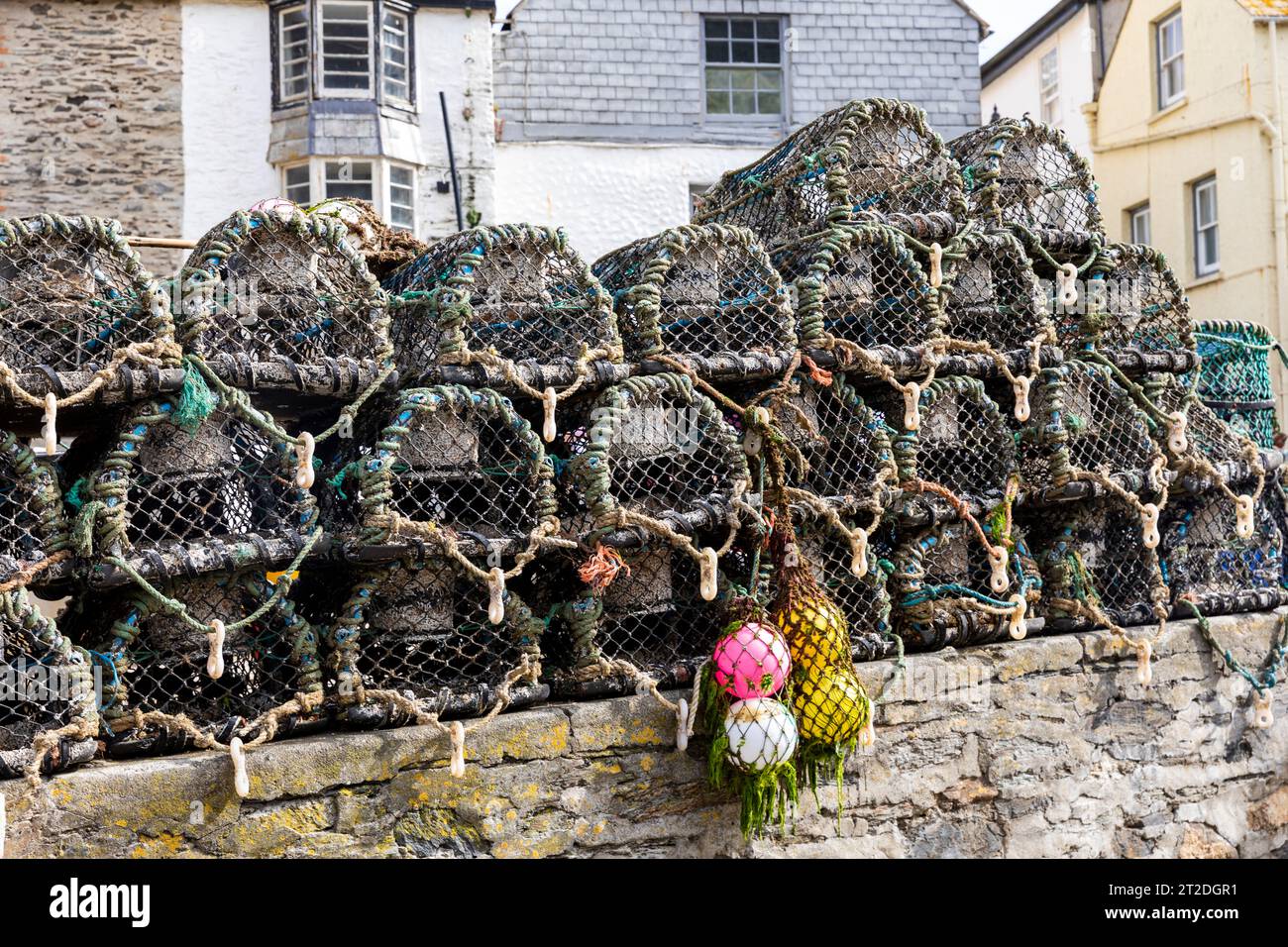 Port Isaac Cornwall, lobster and crab pots stacked on the harbour wall ...