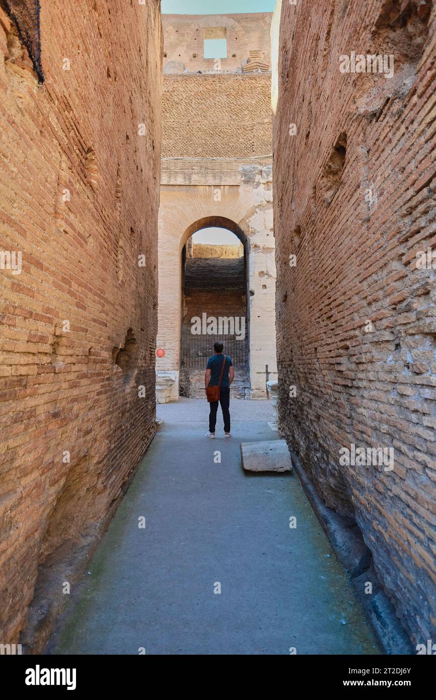 Man standing between the walls in the Colosseum in Rome, Italy Stock ...