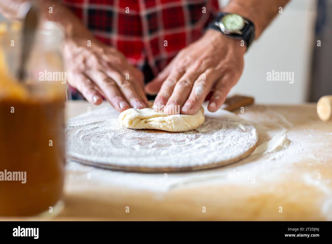 Detail of hands of men rolling the dough. Preparation for baking of ...