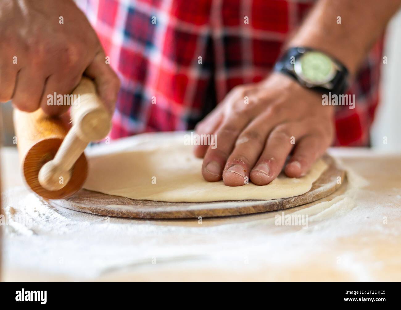 Detail of hands of men rolling the dough. Preparation for baking of ...