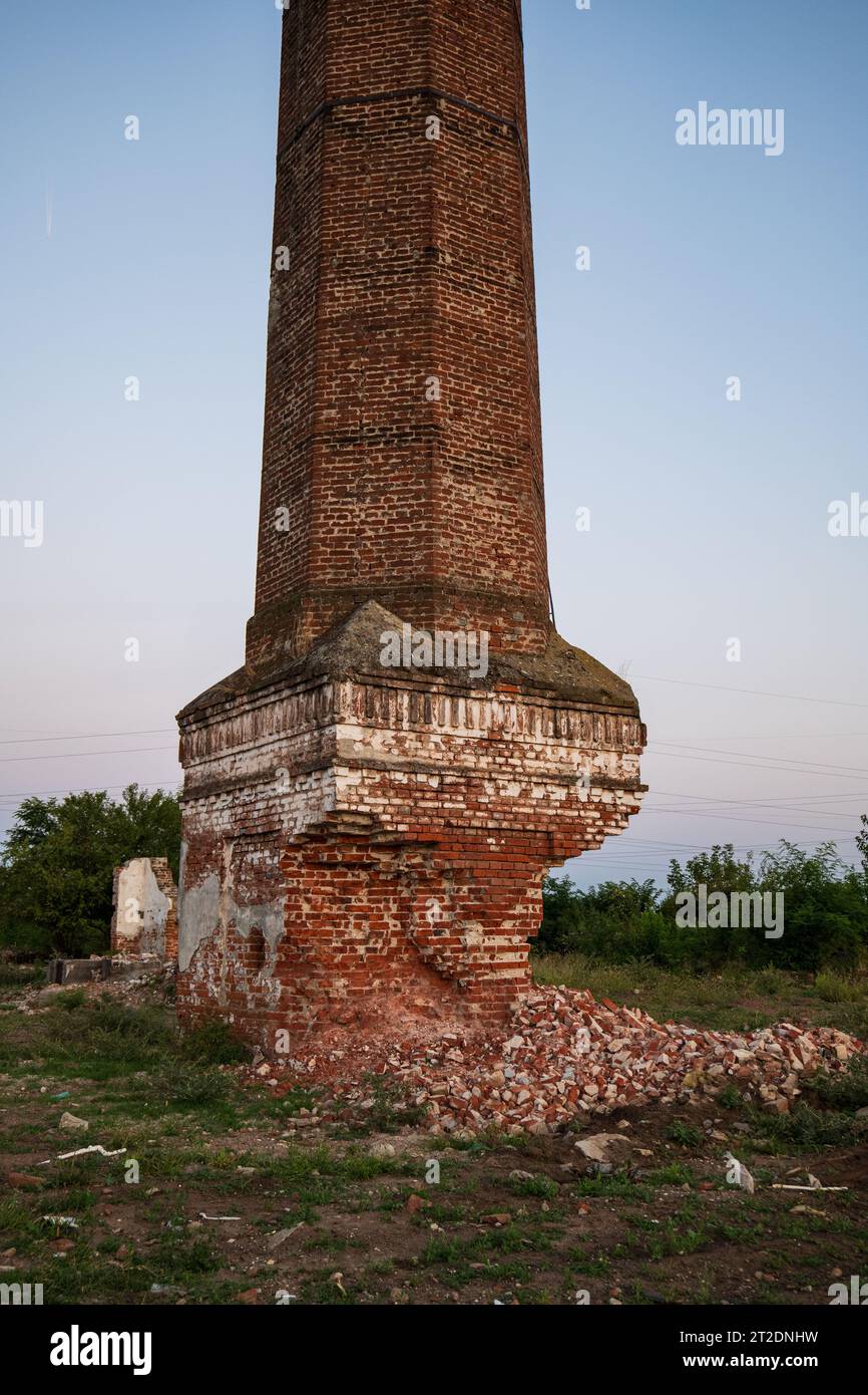 Old, run down, decaying, tall brick chimney of an abandoned urban power ...