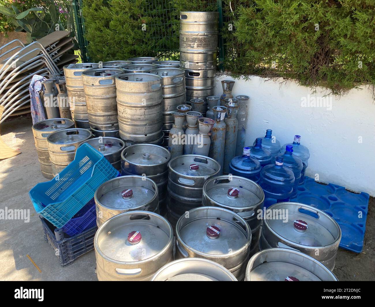 Stock of steel beer kegs on the wooden palettes. Many beer barrels at a ...