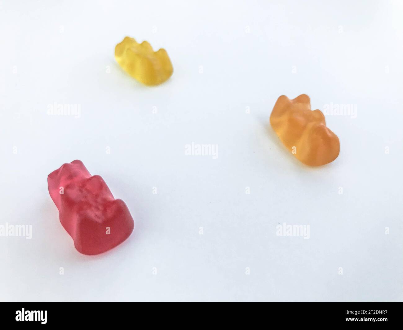 gummy bears on a white matte background. red, yellow and orange bear ...
