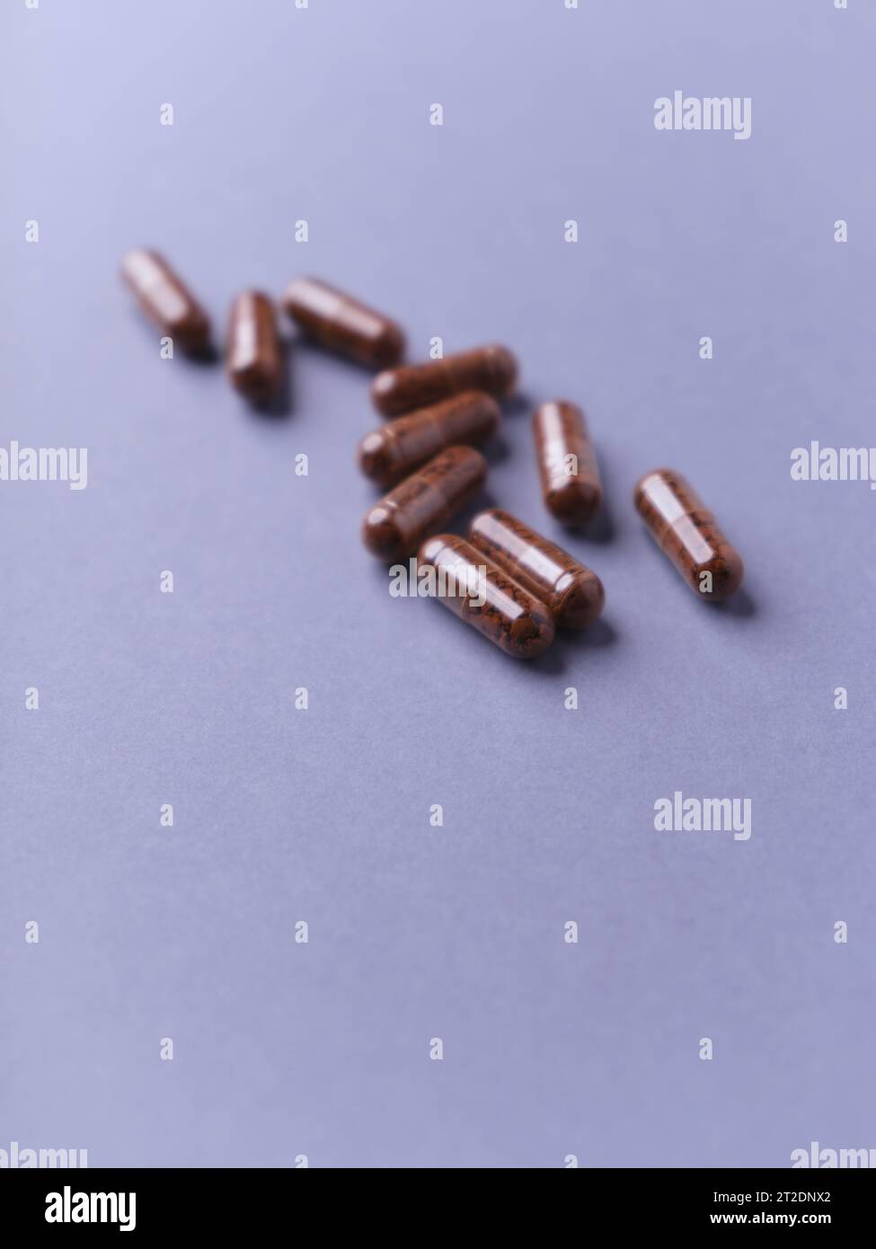 Ashwagandha (Withania somnifera) capsules. Paper background. Soft focus ...