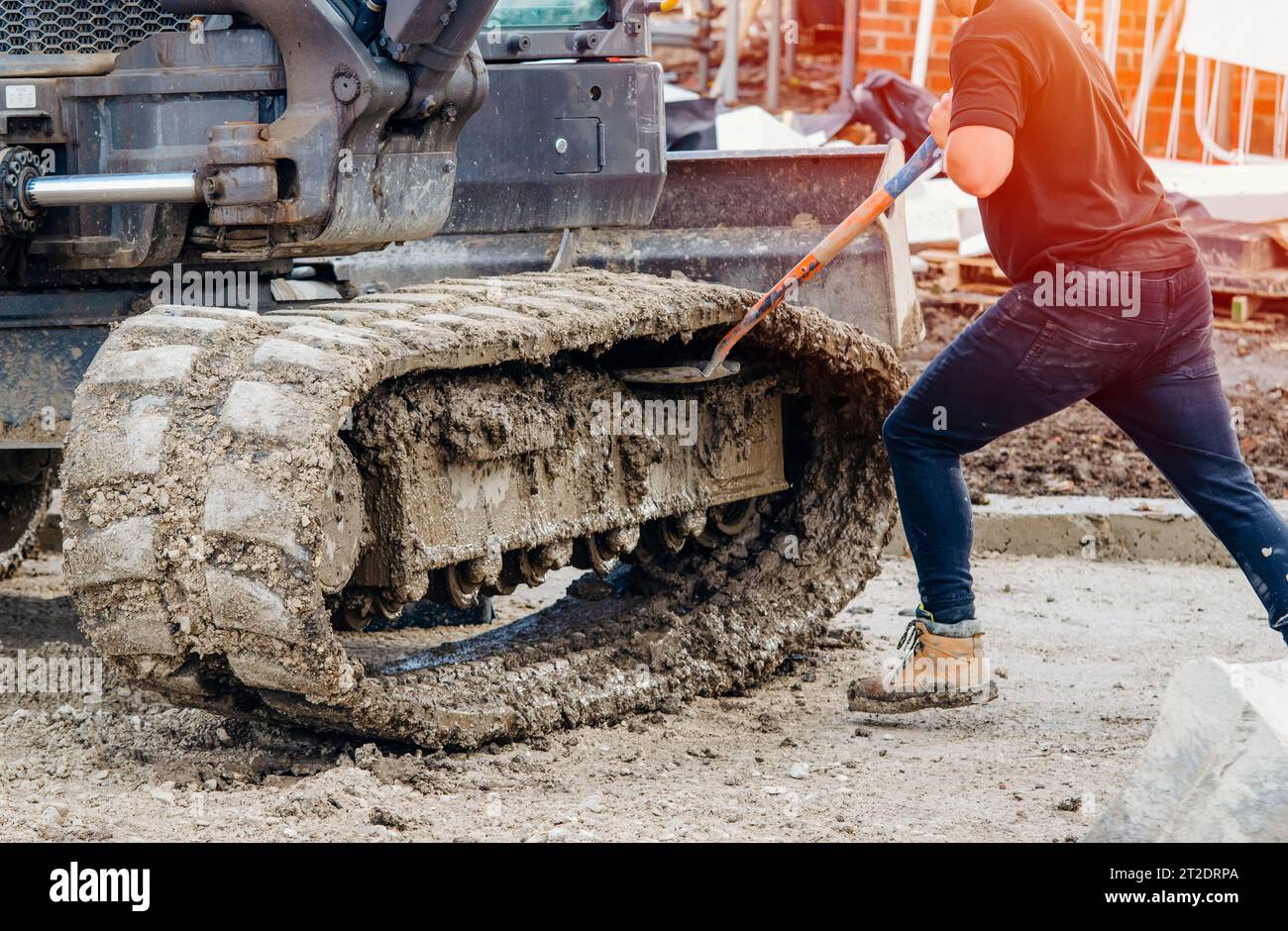 Builder taking broken track of the excavator for replacement or repair ...