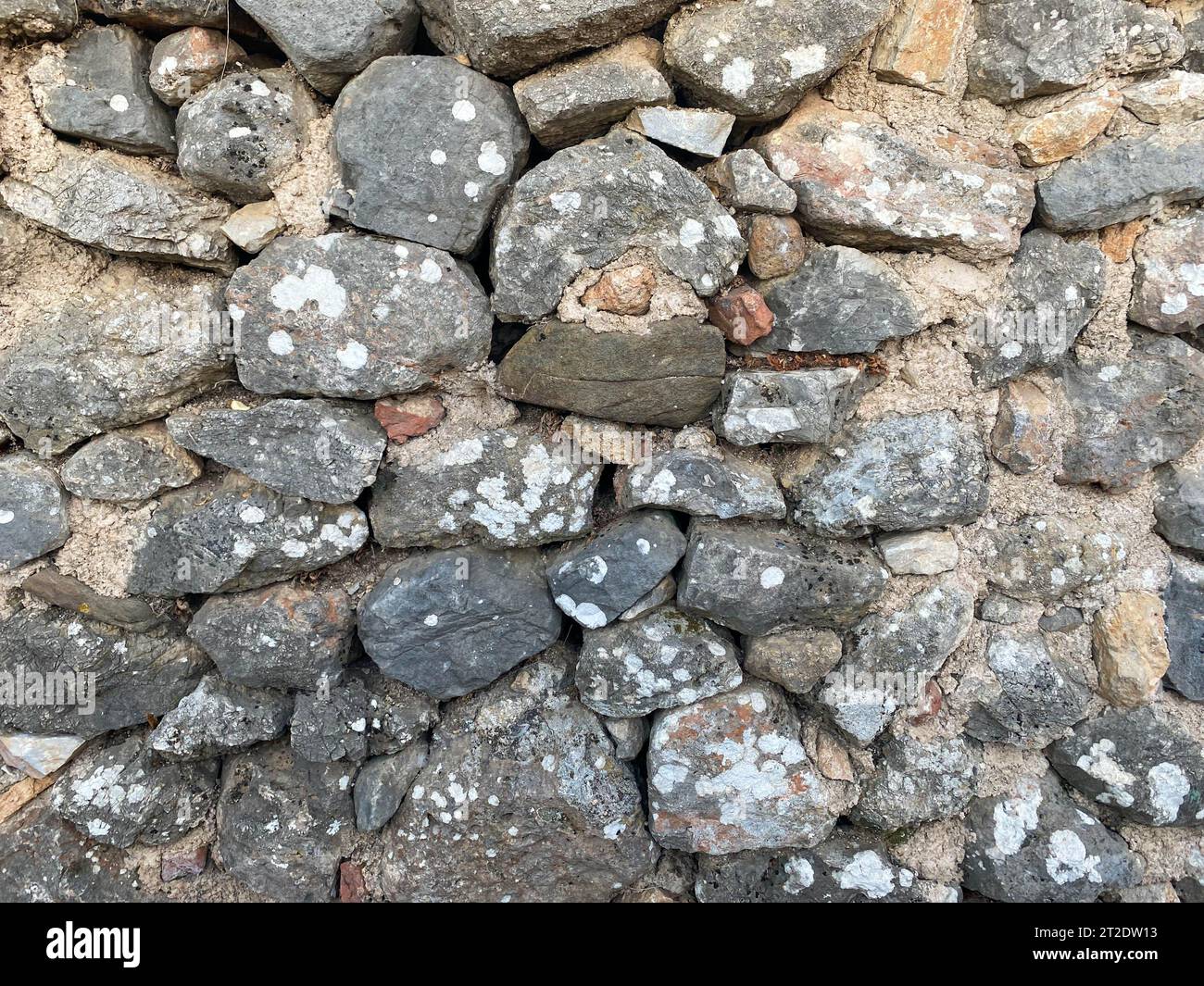 Background, texture, stone wall of round stones cobblestones bricks ...