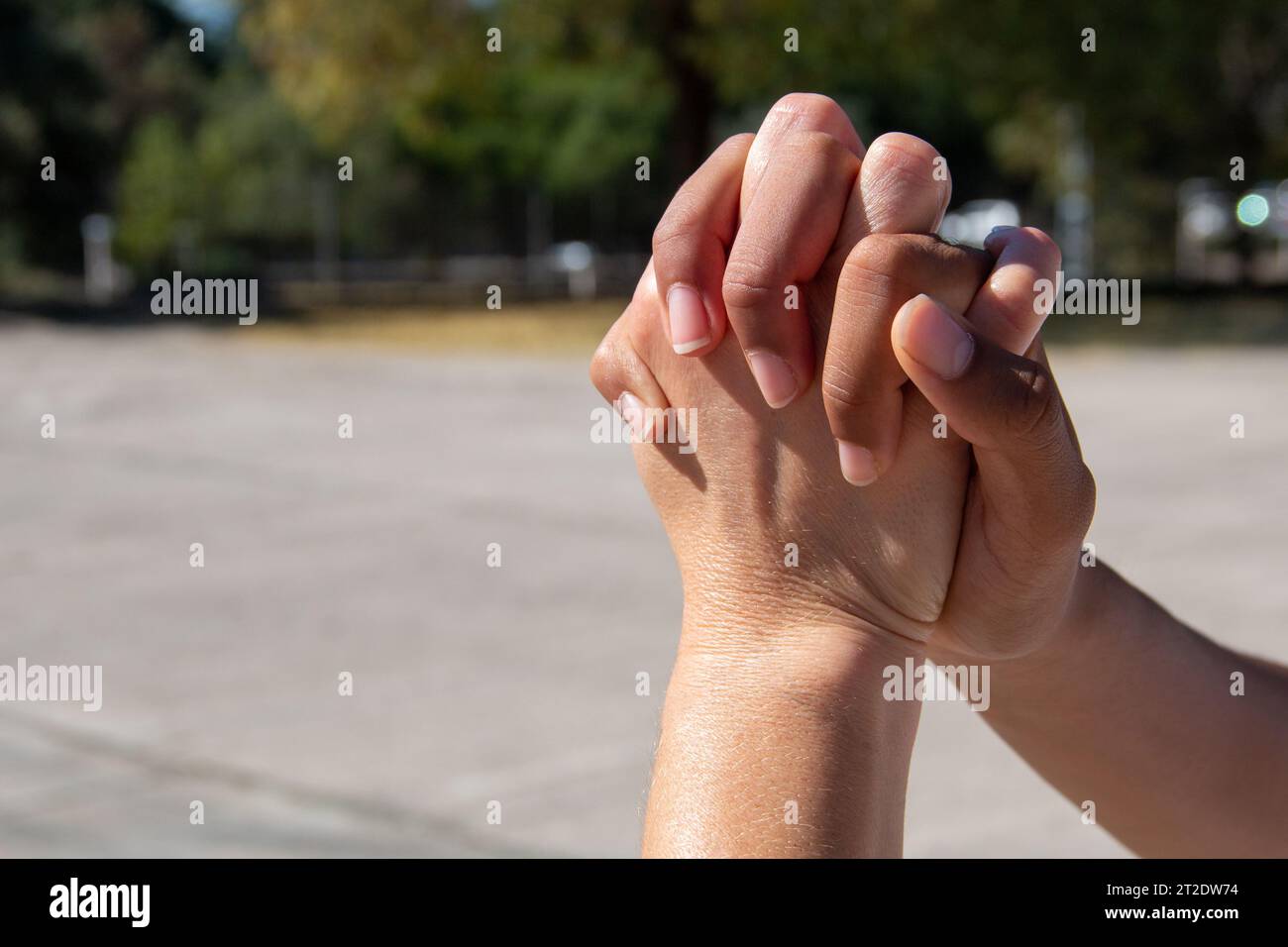 Different ethnicity holding hands hi-res stock photography and images - Alamy