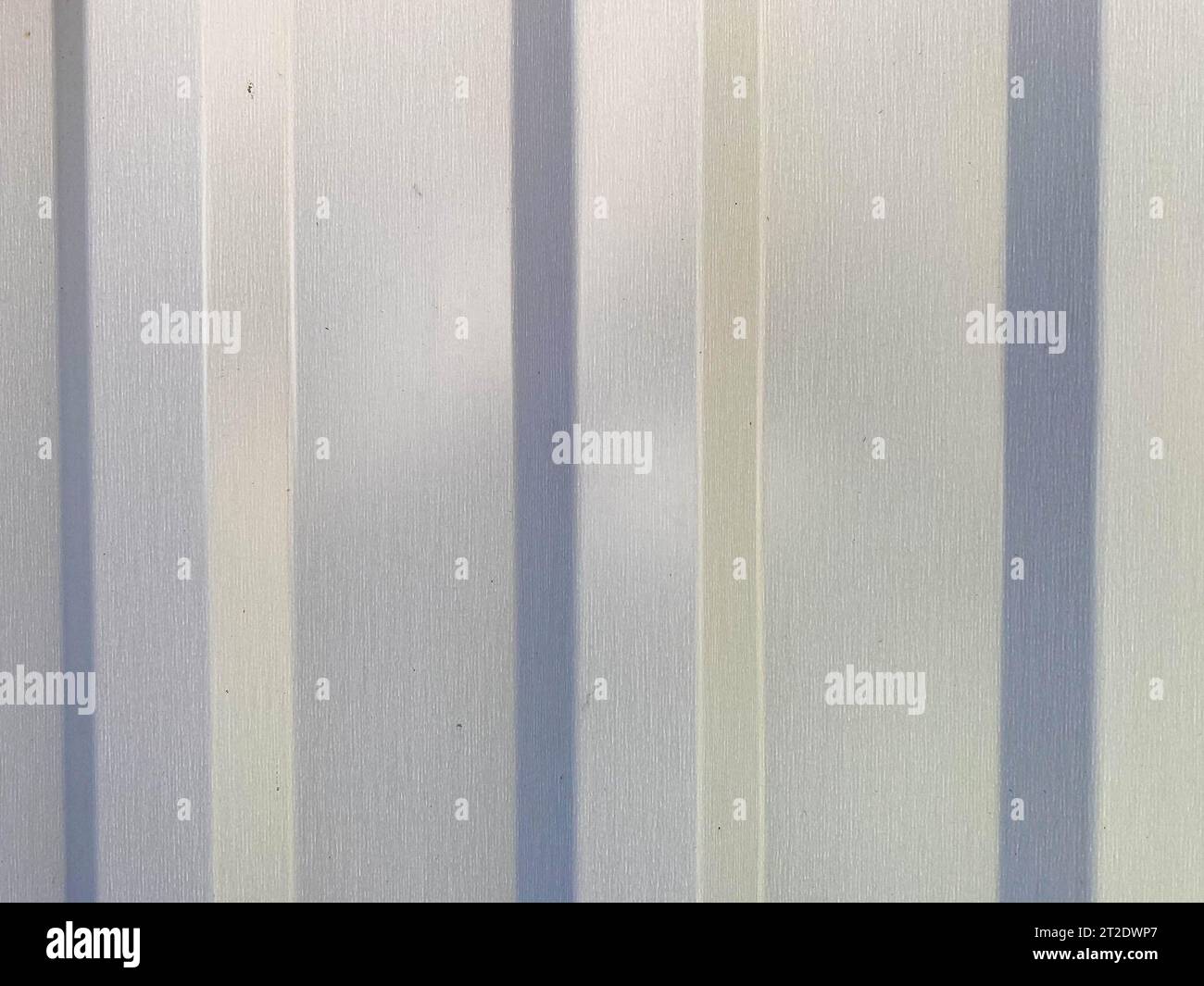 The texture of an iron metal fence and a gray unpainted surface of tin ...