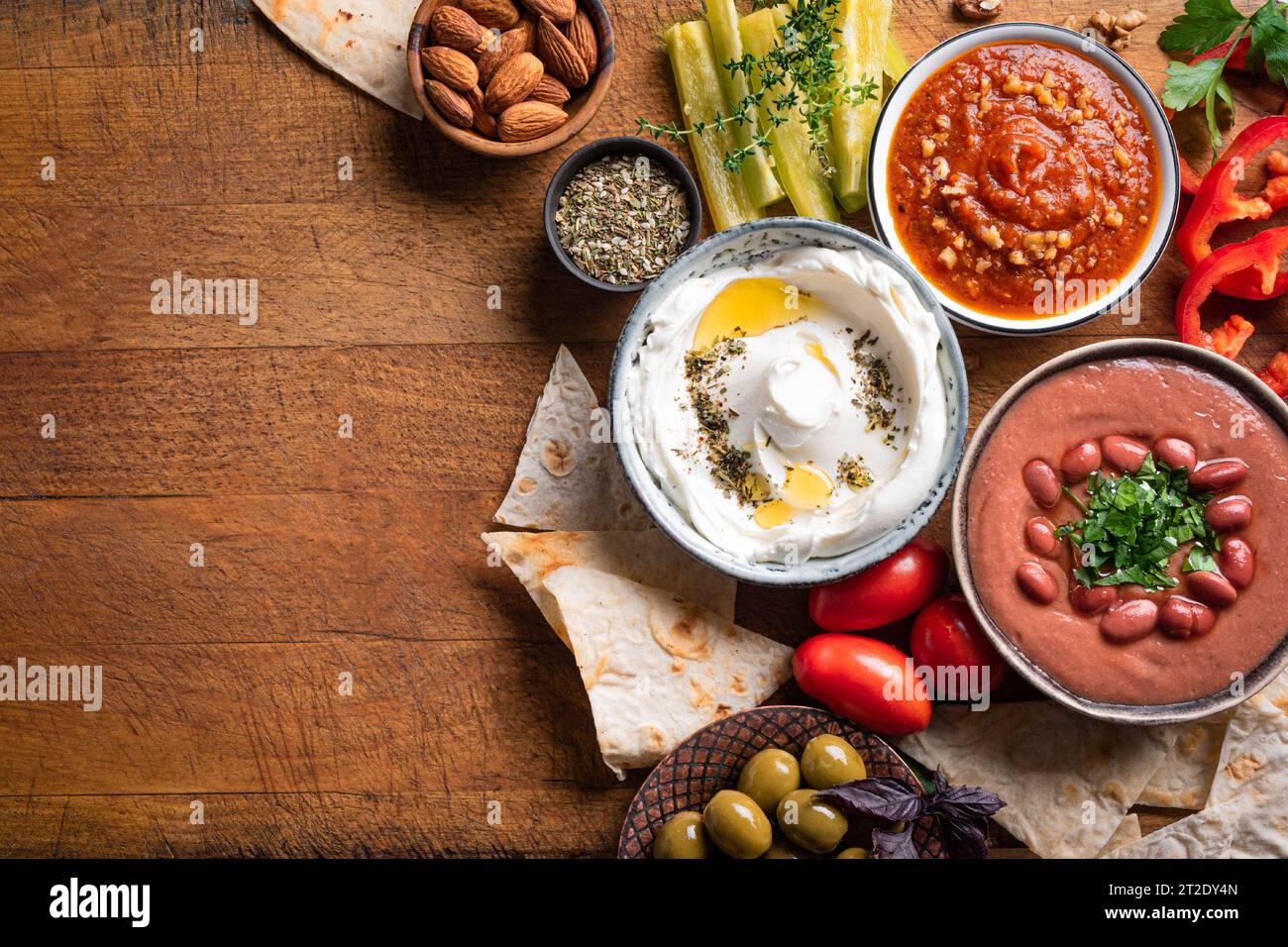 Selection of arabic mezze food - foul, labneh yogurt, muhamara dip on ...