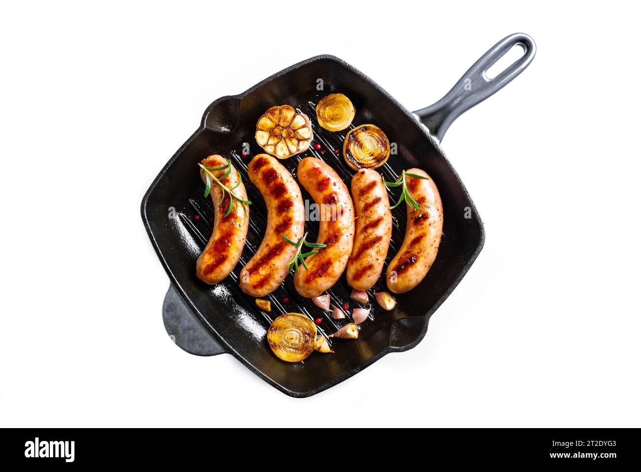 Grilled sausages with garlic and herbs on cast iron grill pan isolated ...