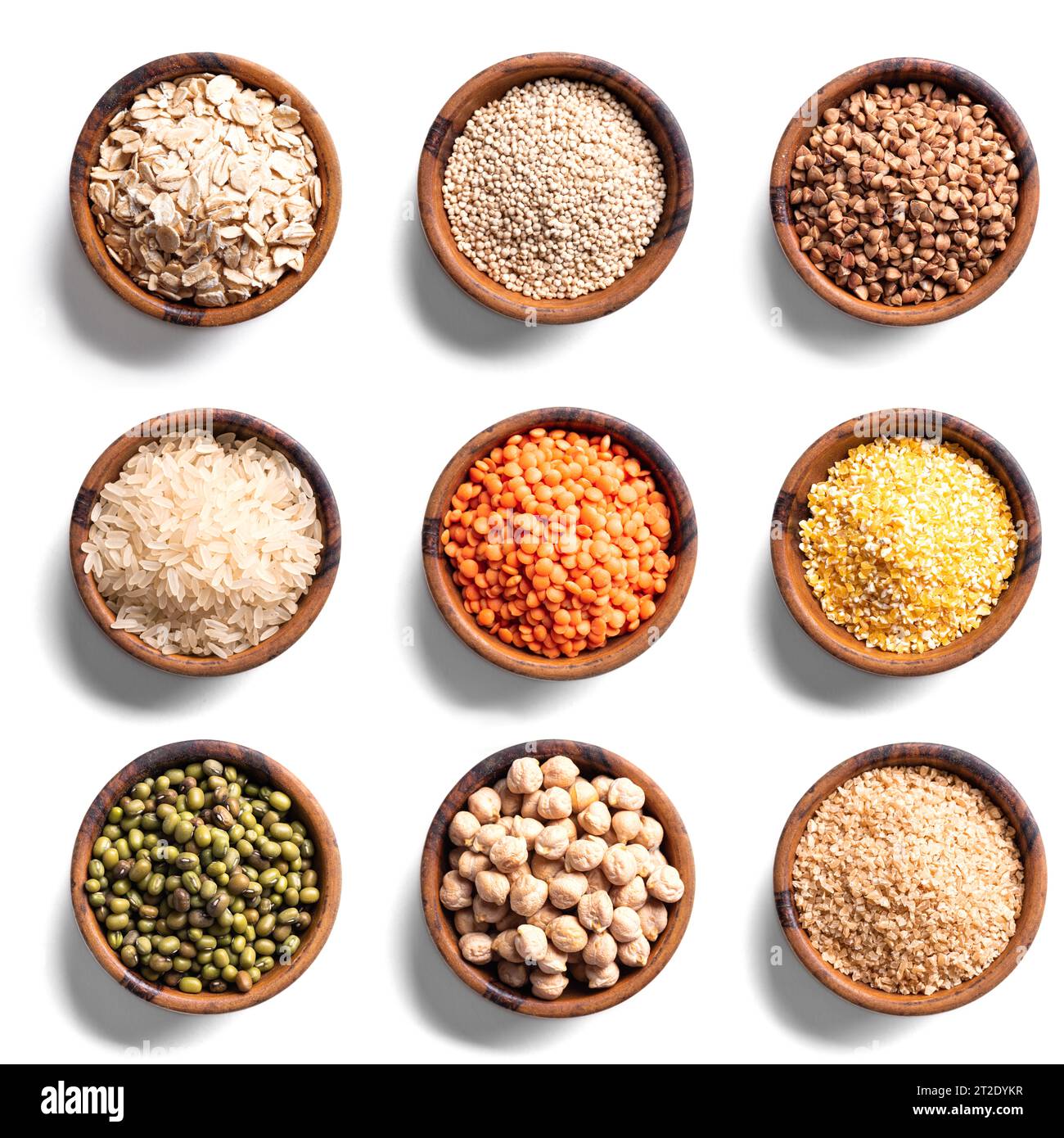 Various grains in wooden bowls isolated on white background, top view ...