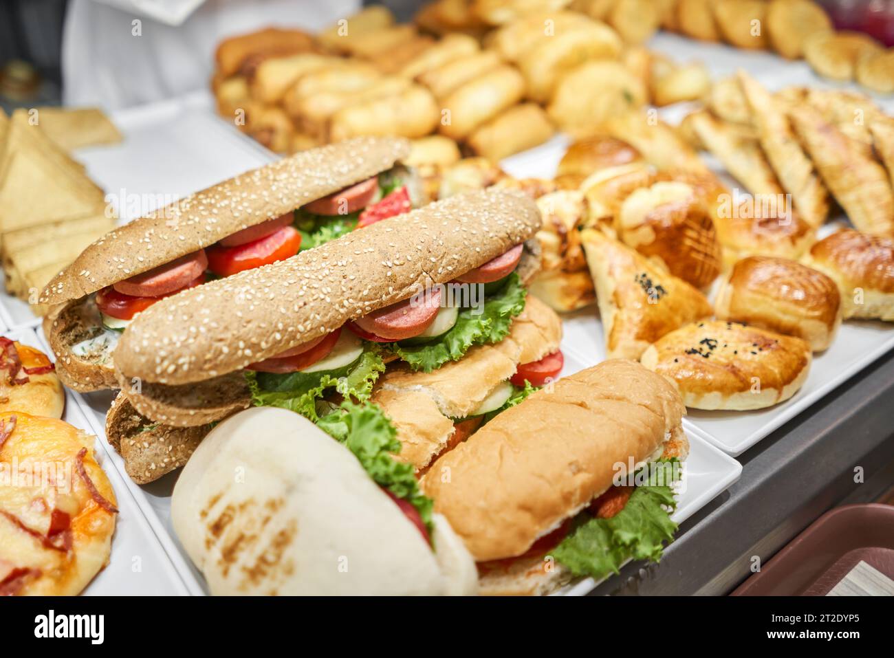 Fresh sandwiches, pies and pizza to choose from in the window of a cafe, buffet or self-service ...