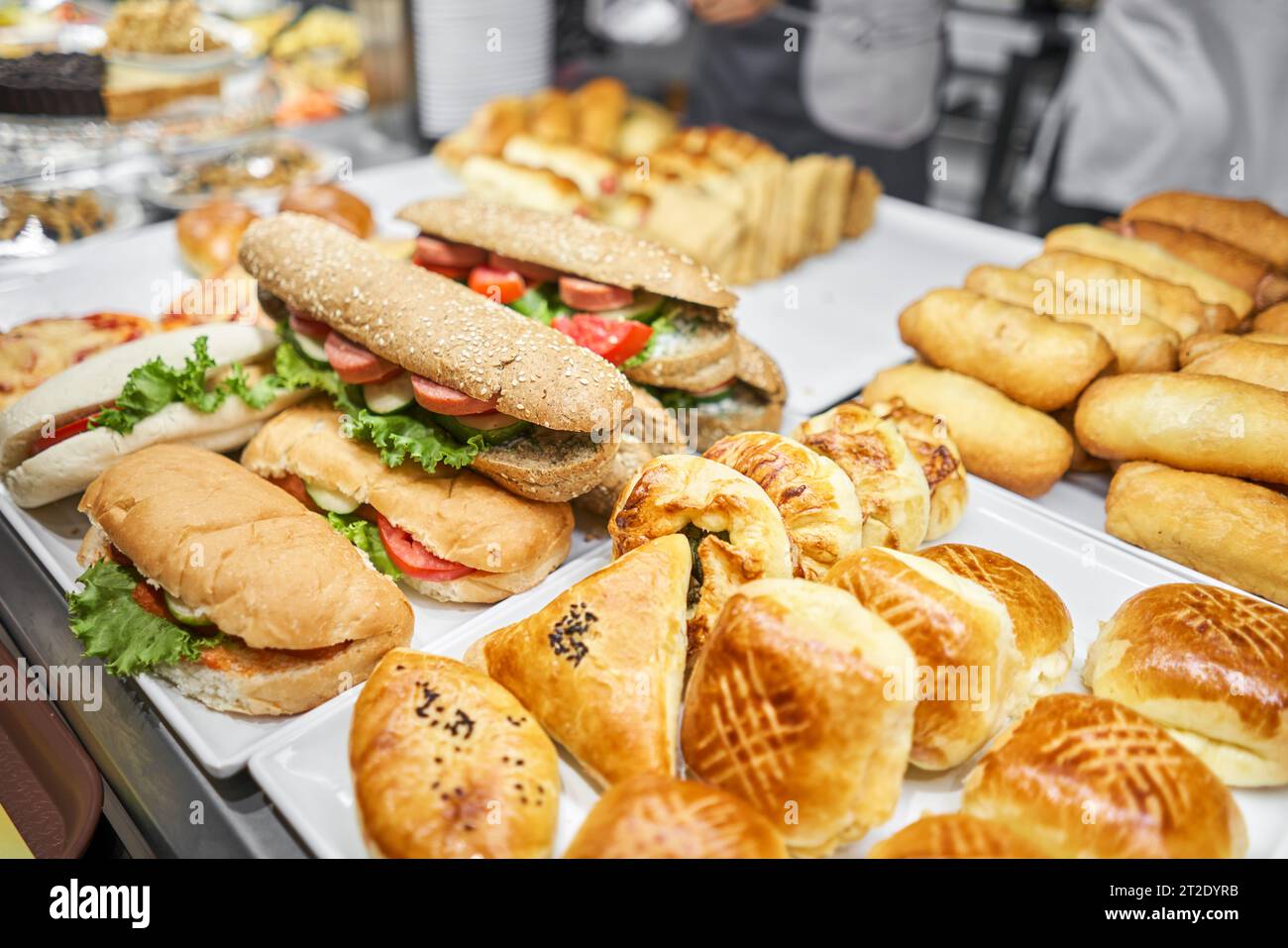 Fresh sandwiches, pies and pizza to choose from in the window of a cafe, buffet or self-service ...