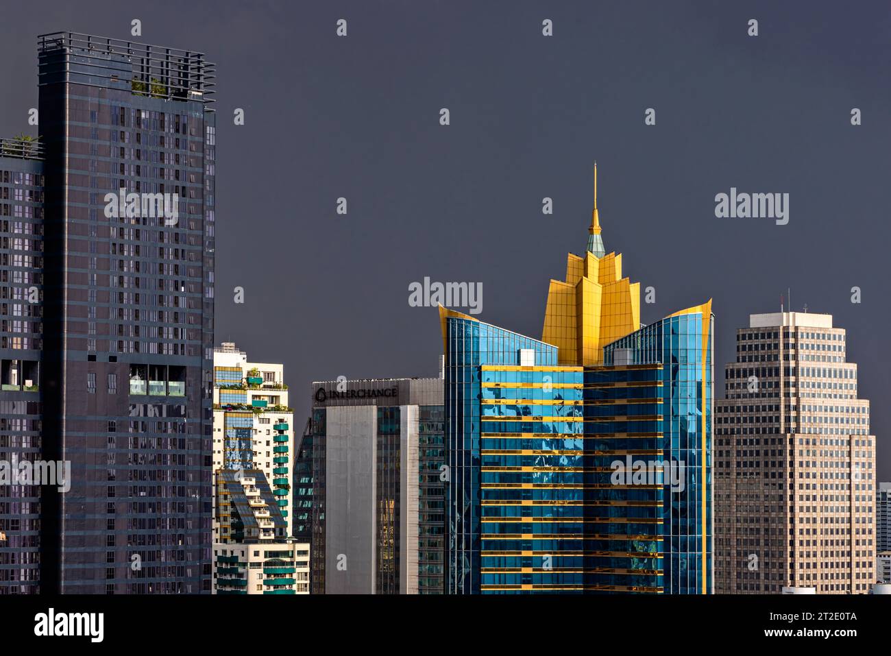 Sun and storm clouds over Bangkok high rise skyline, Sukhumvit area ...
