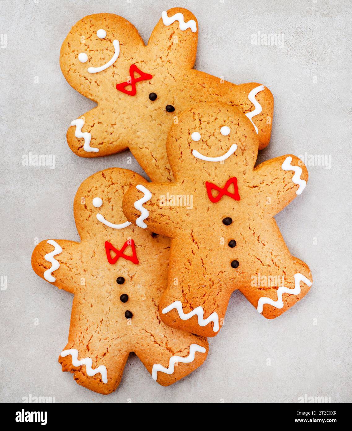 Three gingerbread men on mottled grey surface Stock Photo - Alamy