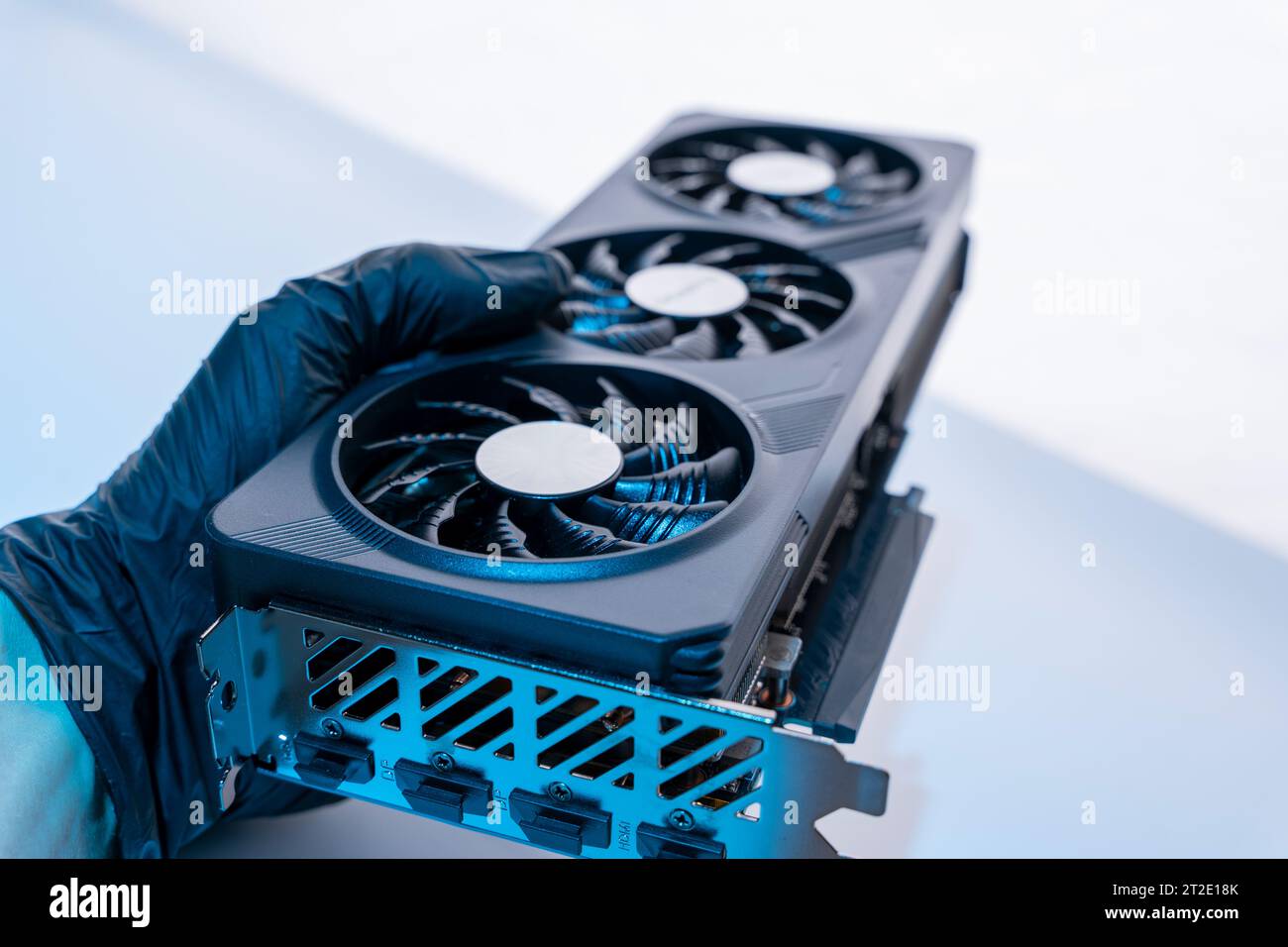 the hand of a computer technician holds a modern powerful video game ...