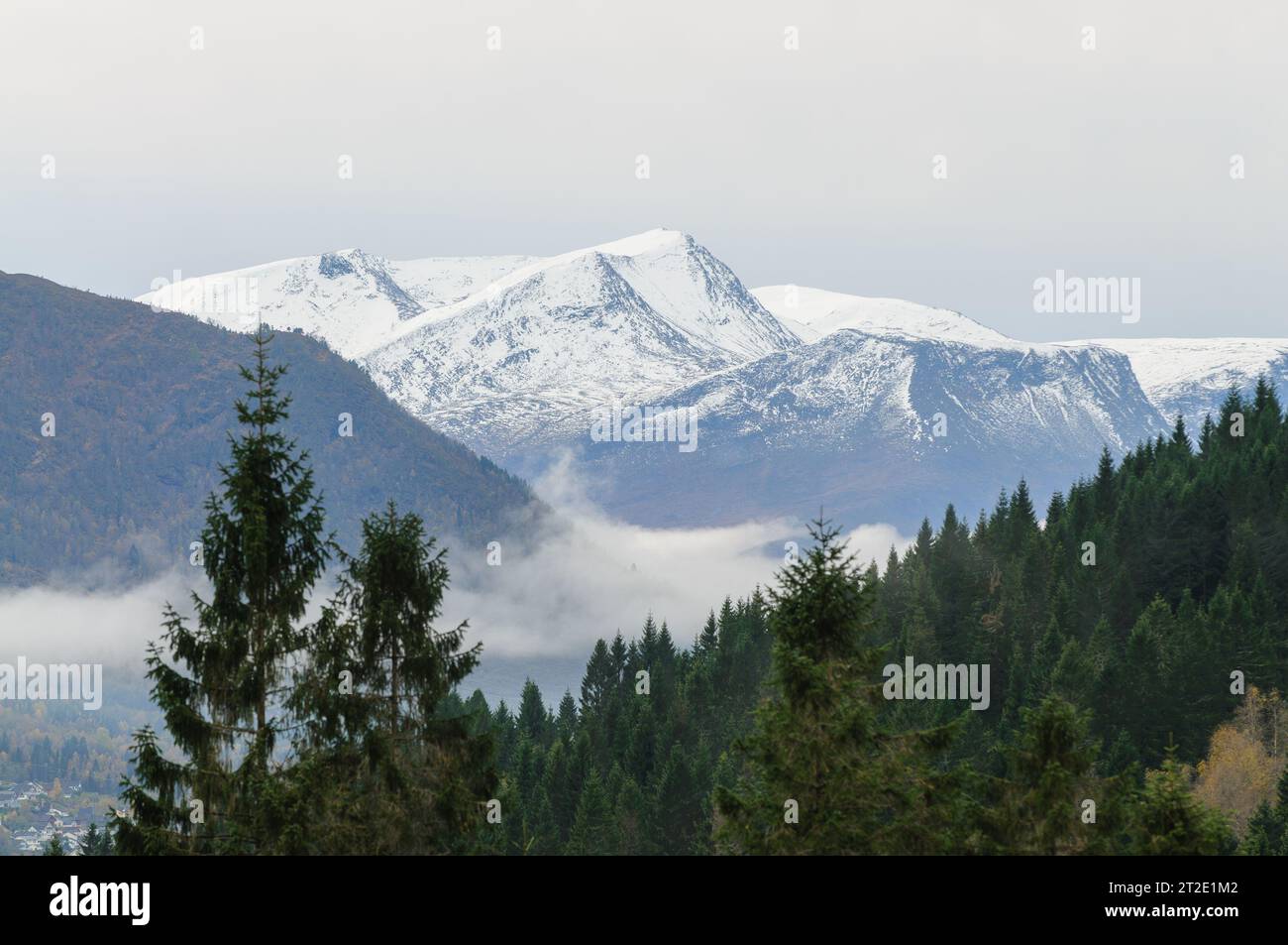snow-capped mountain peaks above mist-covered valleys Stock Photo - Alamy