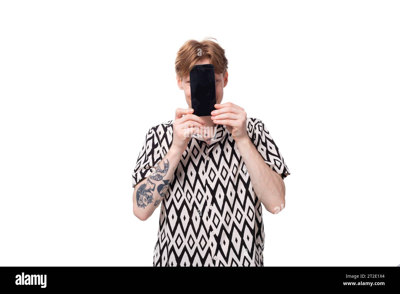 young caucasian man with red hair and a tattoo is dressed in a shirt ...