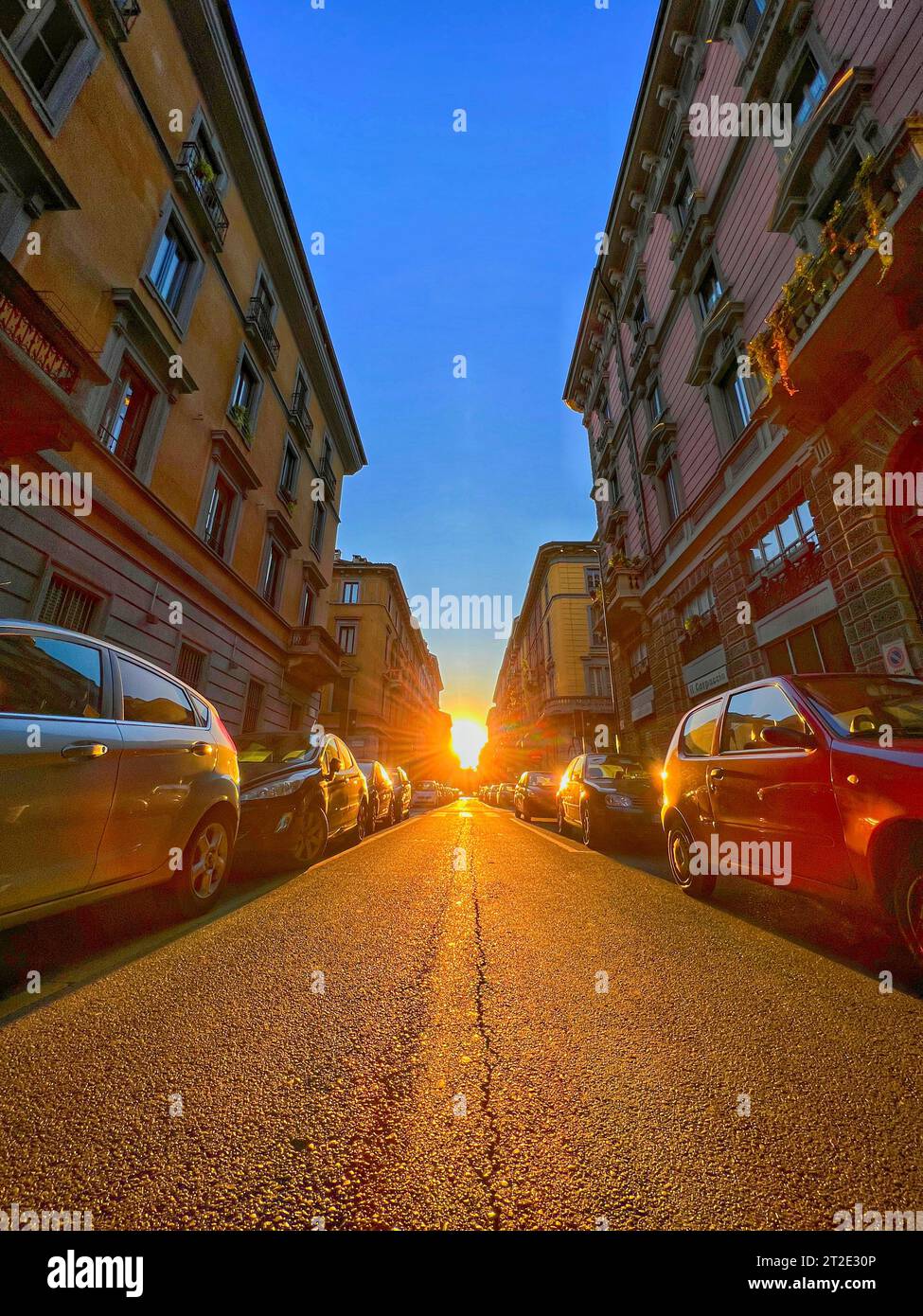 Milan dawn at the end of the street between the buildings. High quality ...