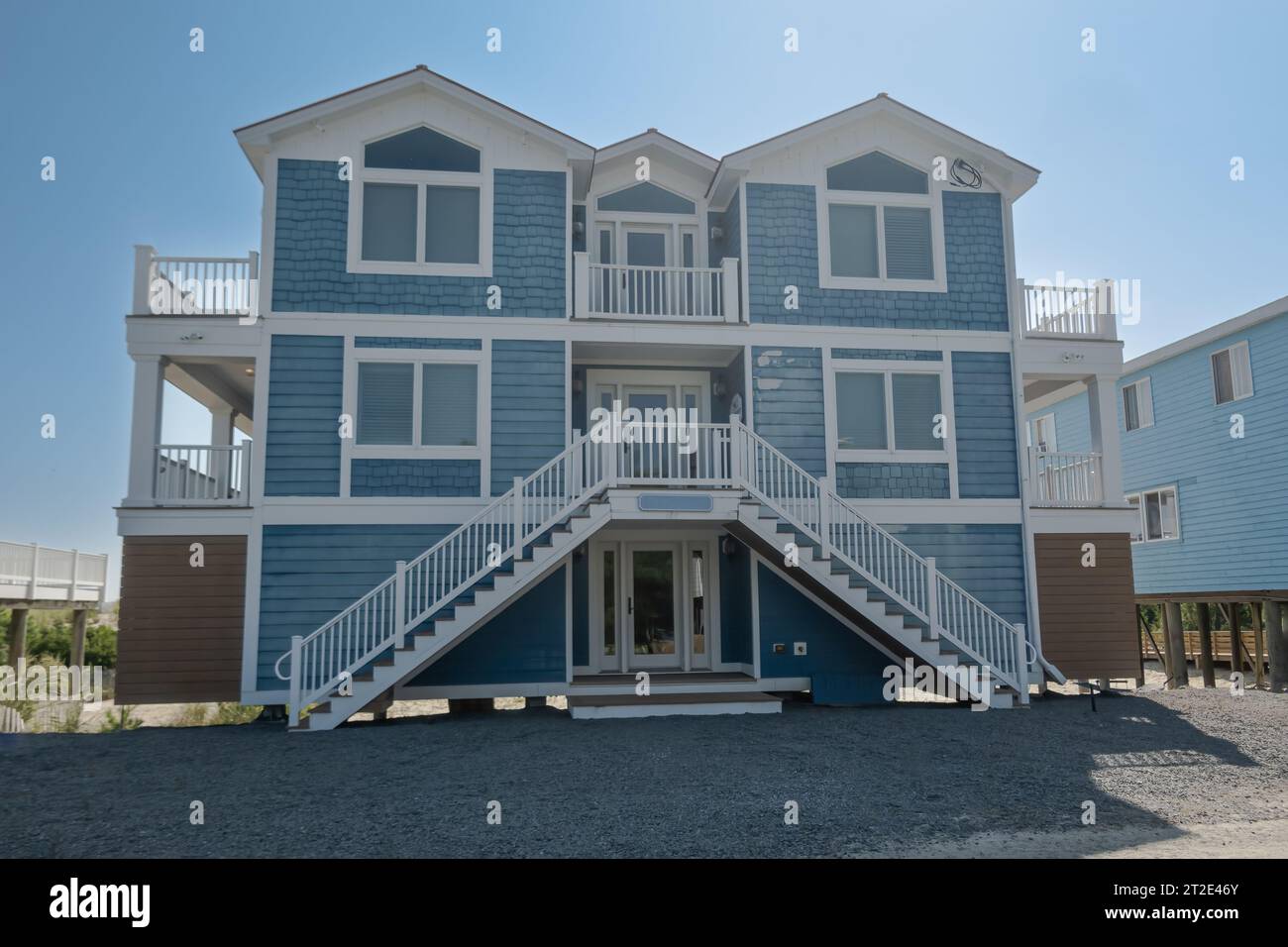 A picture of a stunning two-story beach house, located on the edge of a ...