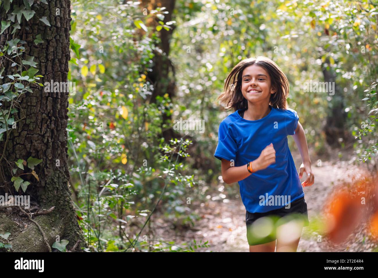 girl practicing trail running in the woods Stock Photo - Alamy