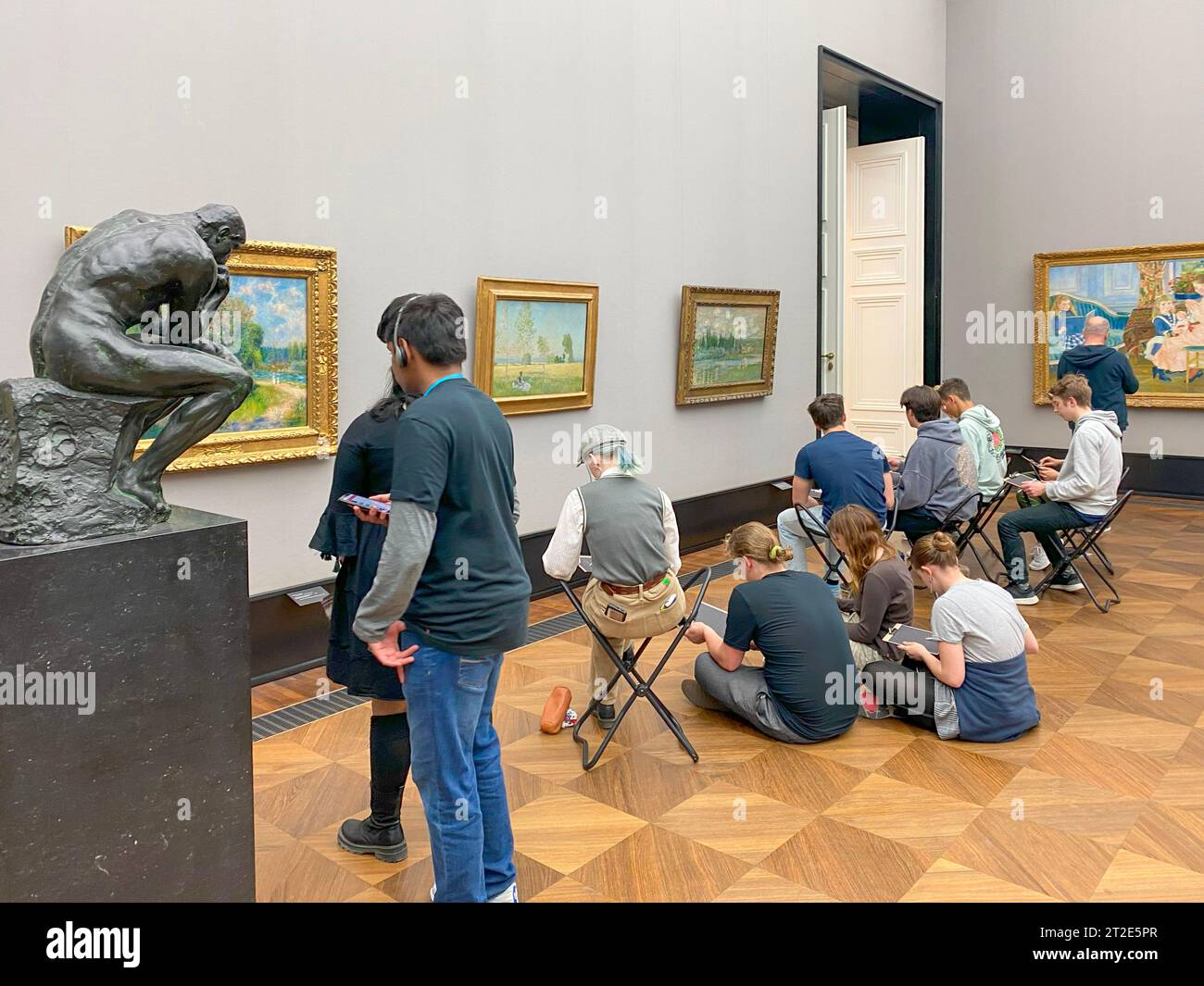 Art students studying paintings at Alte Nationalgalerie Berlin, Germany ...