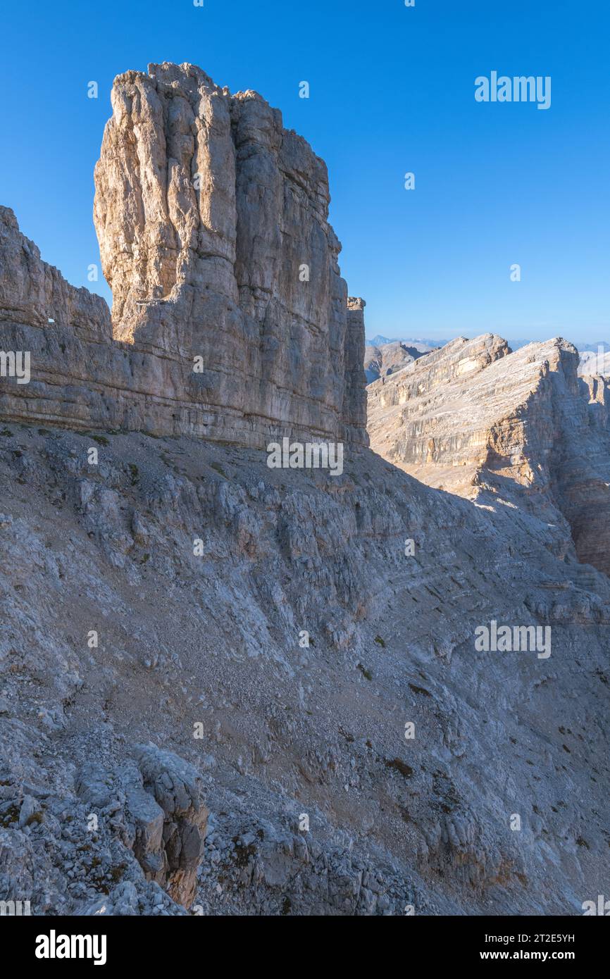 Tall limestone butte on a mountain ridge in the Ampezzo Dolomites of ...