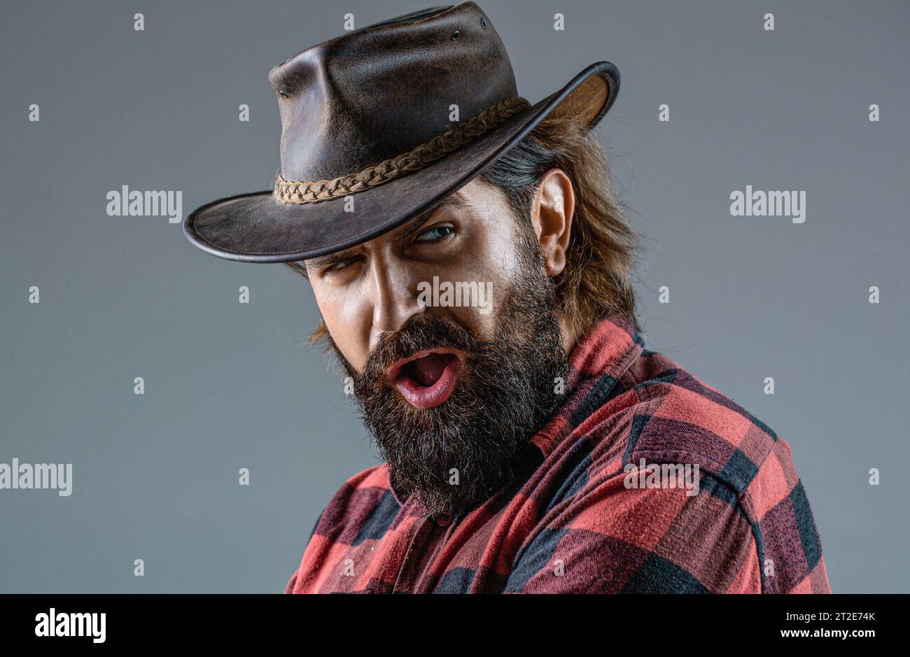 Portrait of cowboy in hat. Portrait of man wearing cowboy hat, gun ...