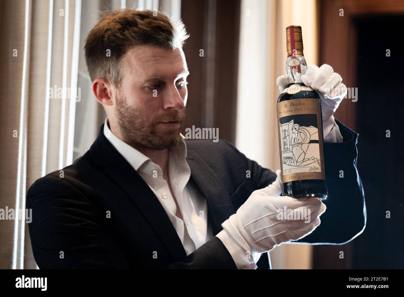 A bottle of Macallan Adami 1926 is held during a photocall - the world ...