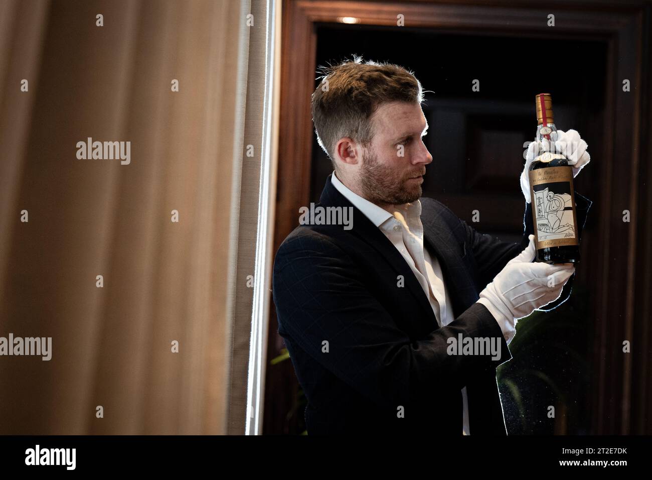 A bottle of Macallan Adami 1926 is held during a photocall - the world ...