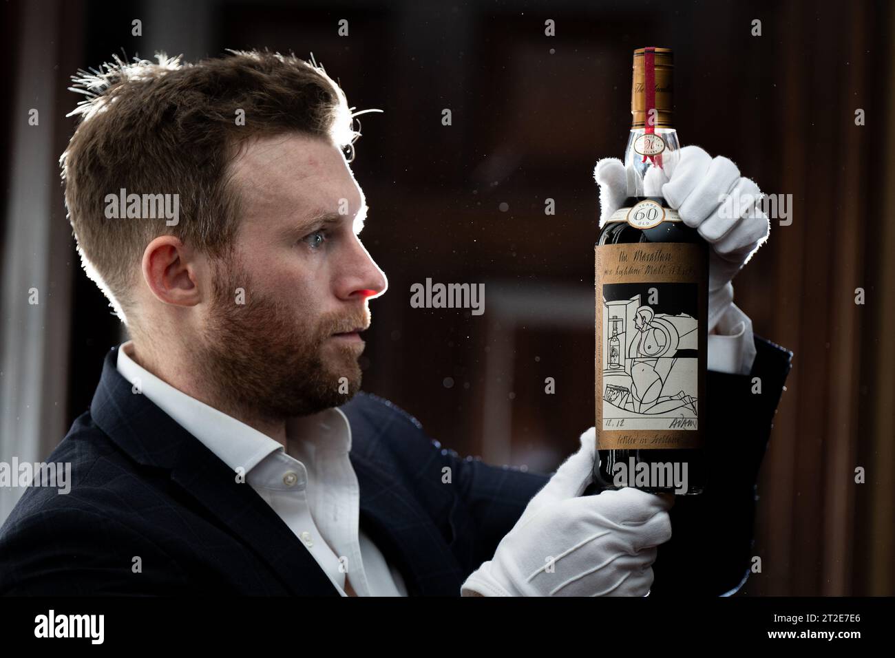 A bottle of Macallan Adami 1926 is held during a photocall - the world ...
