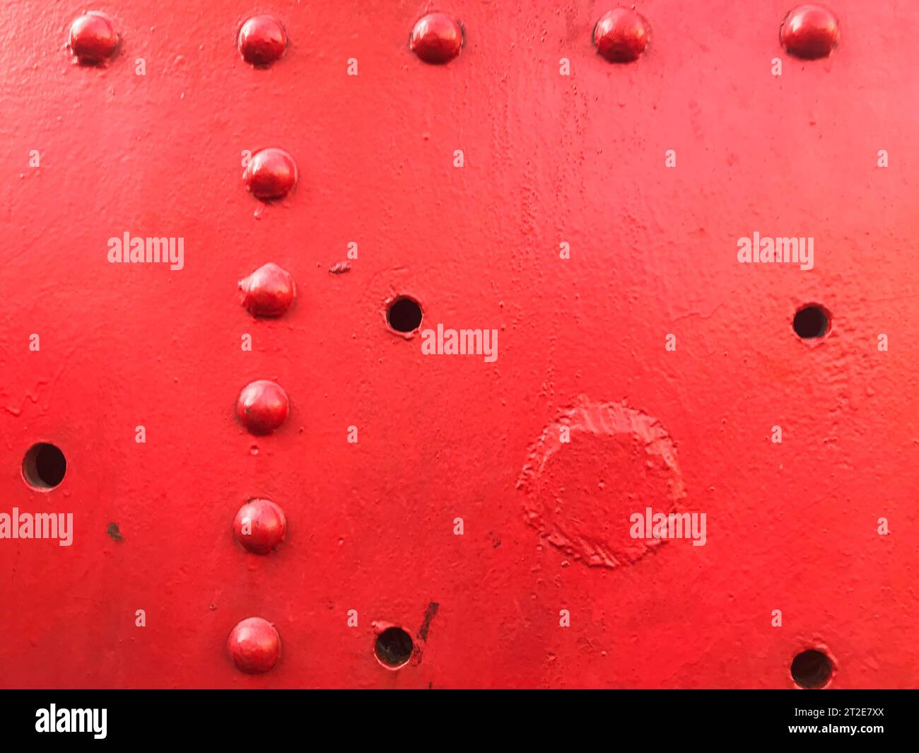 Red iron metal rough painted strong solid industrial wall with rivet ...