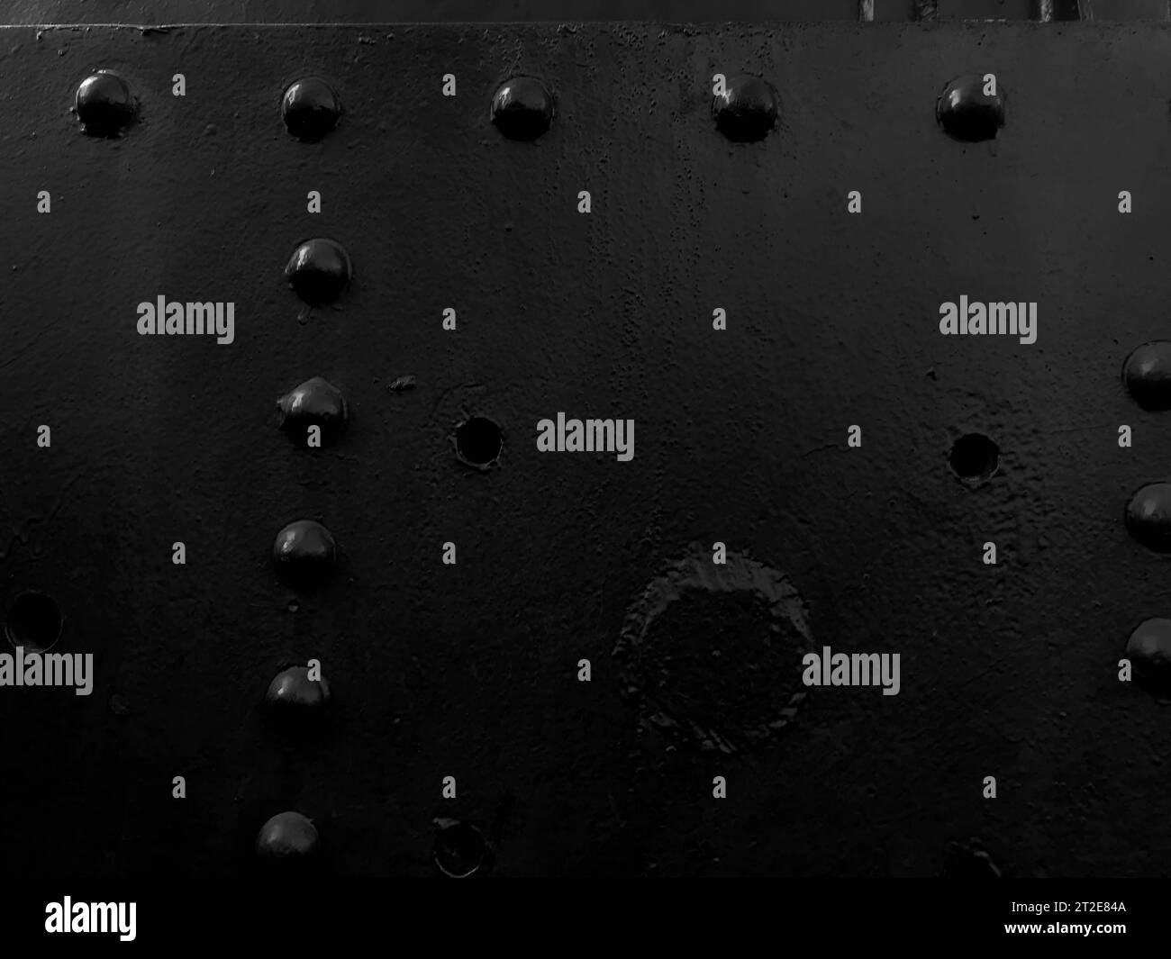 Black iron metal rough painted strong solid industrial wall with rivet ...