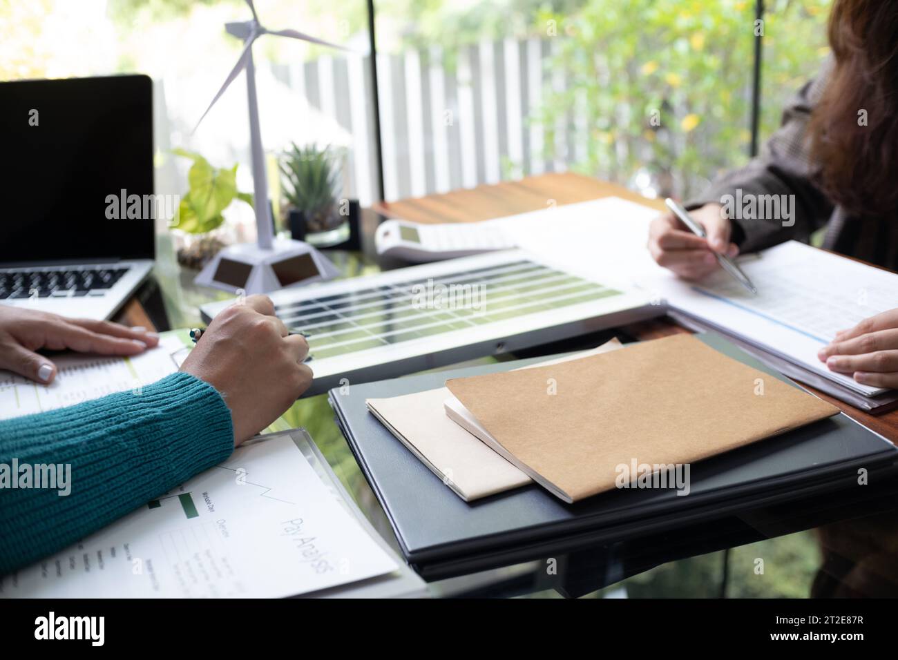A sales representative presenting solar and wind power, alternative ...