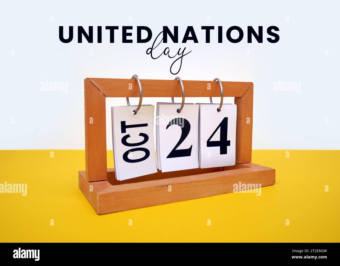 Wooden block with engraved sentence October 24 on a yellow background ...