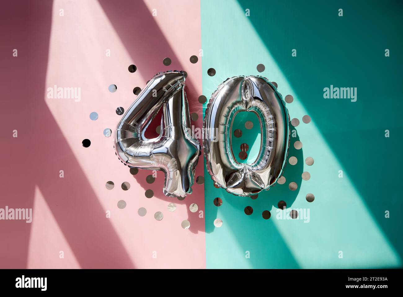 Silver numbers 40 forty years balloons among confetti in sunlight on ...