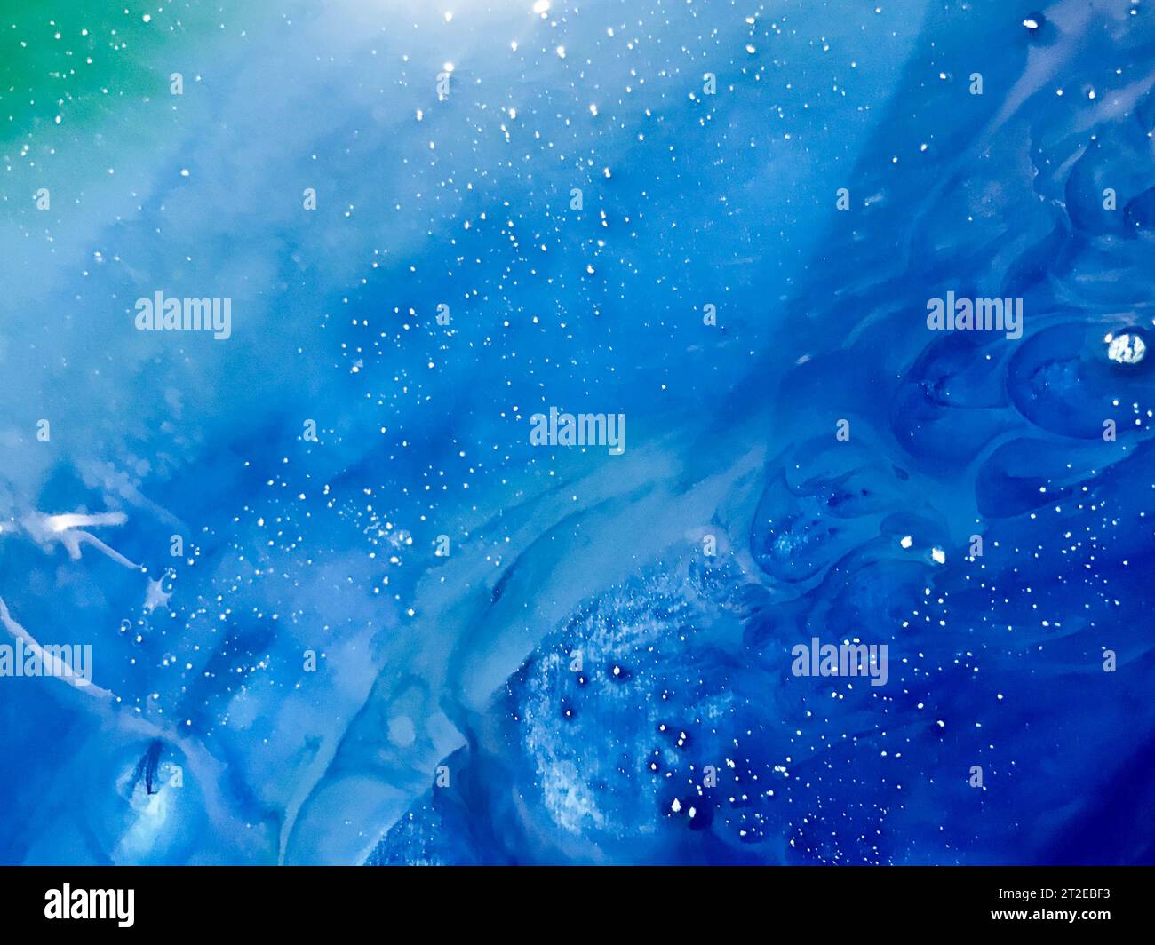 green-blue sea wave with epoxy bubbles. Abstract background on a wooden ...