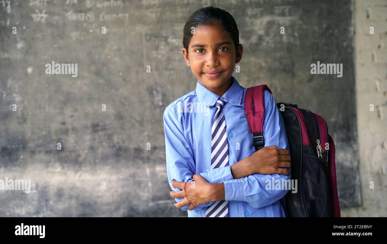 Smiling Indian Rural school boy with backpack looking at camera ...