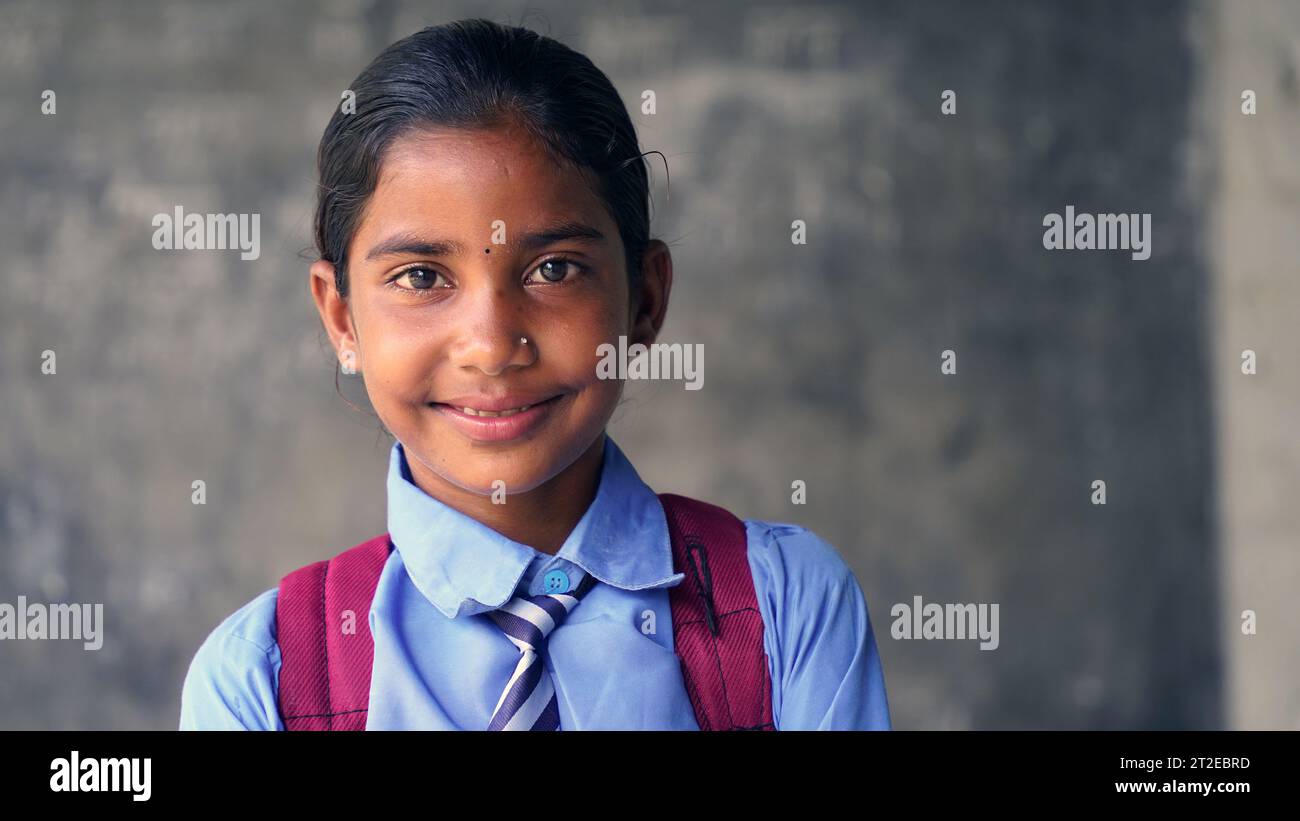 Smiling Indian Rural school boy with backpack looking at camera ...