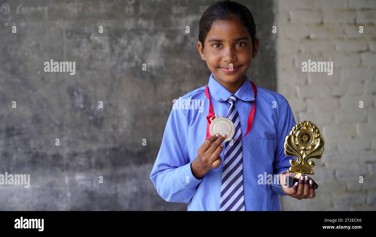 Portrait of a Happy School girl wearing school uniform celebrating ...