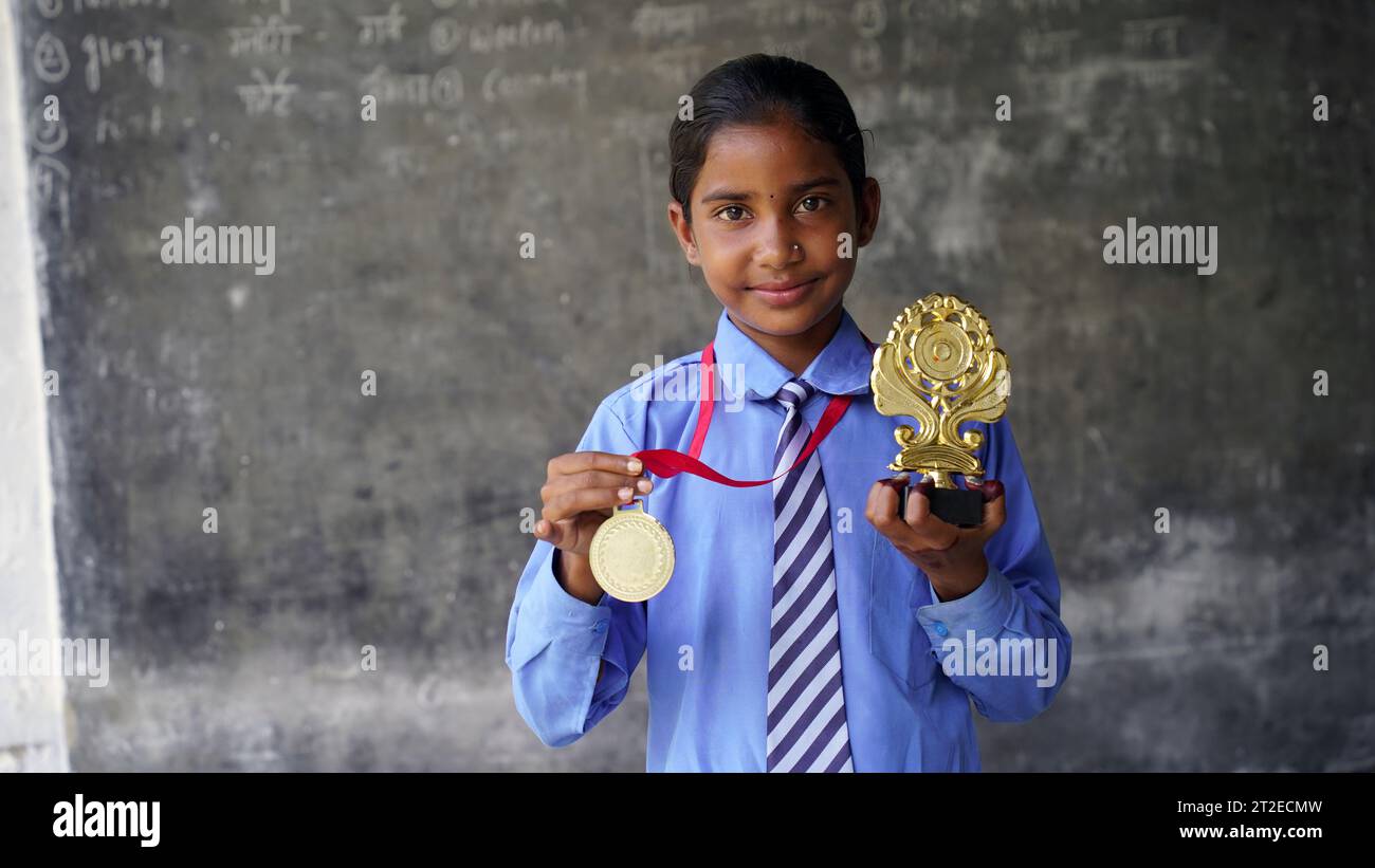 Portrait of a Happy School girl wearing school uniform celebrating ...