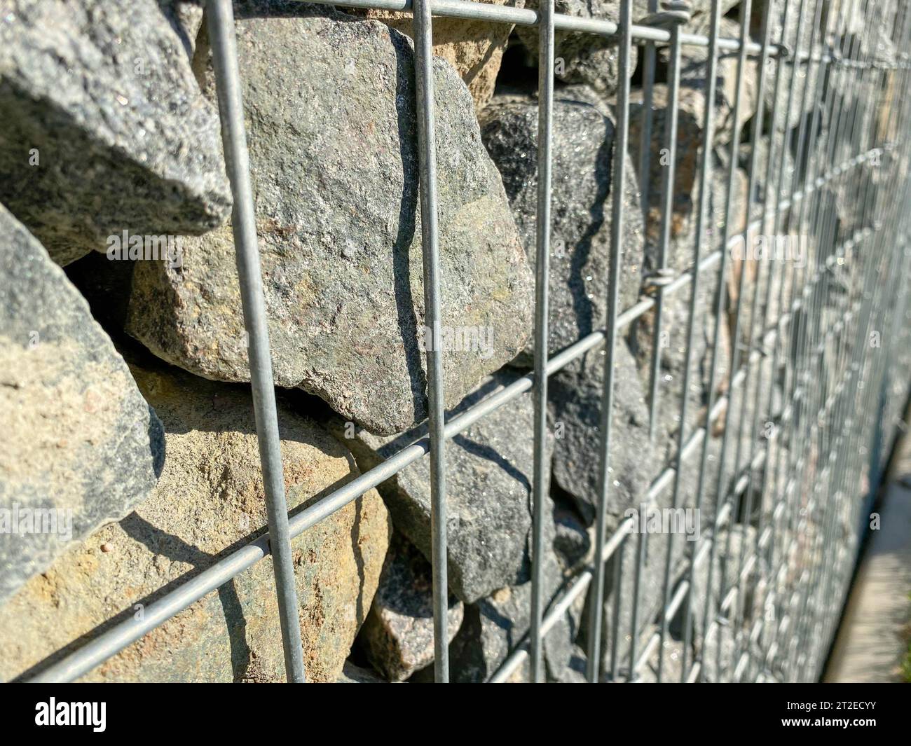 gray stones behind a wire fence. reinforcing structure in construction ...